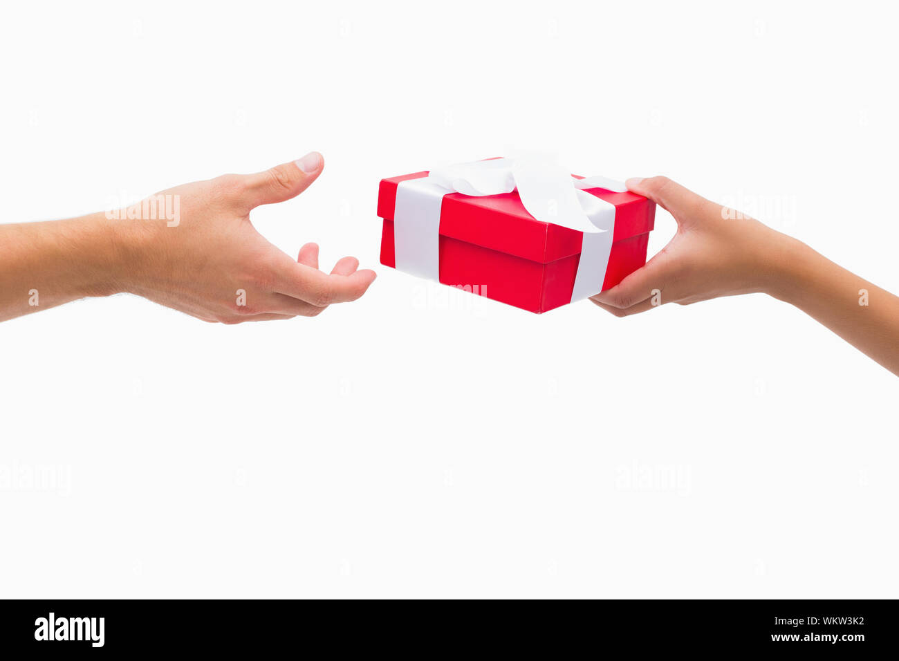 Woman passing man a gift on white background Stock Photo - Alamy