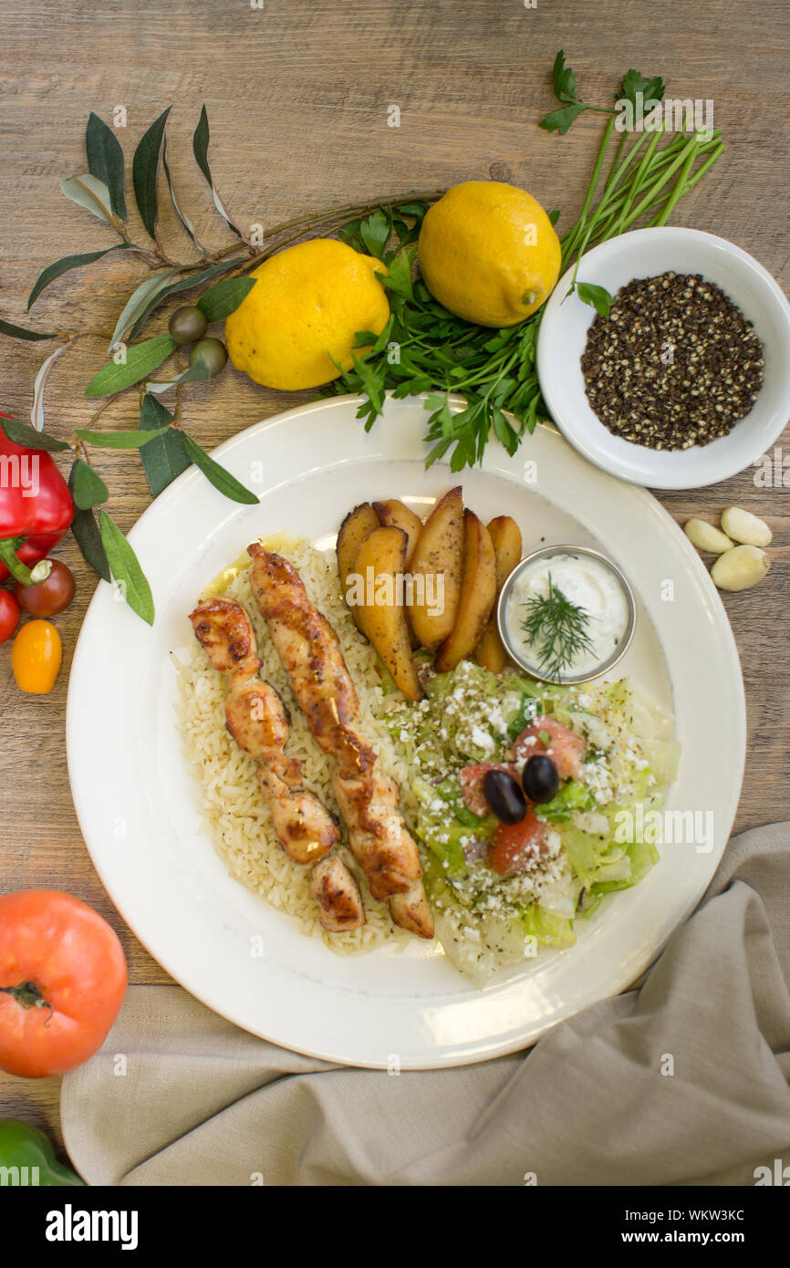 greek grilled kabobs with rice on white plates Stock Photo - Alamy