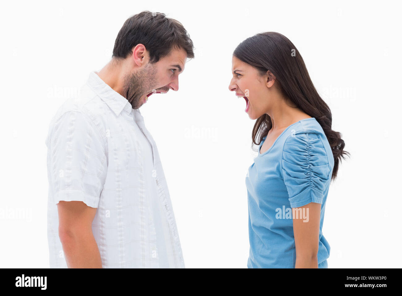 Angry couple shouting at each other on white background Stock Photo - Alamy
