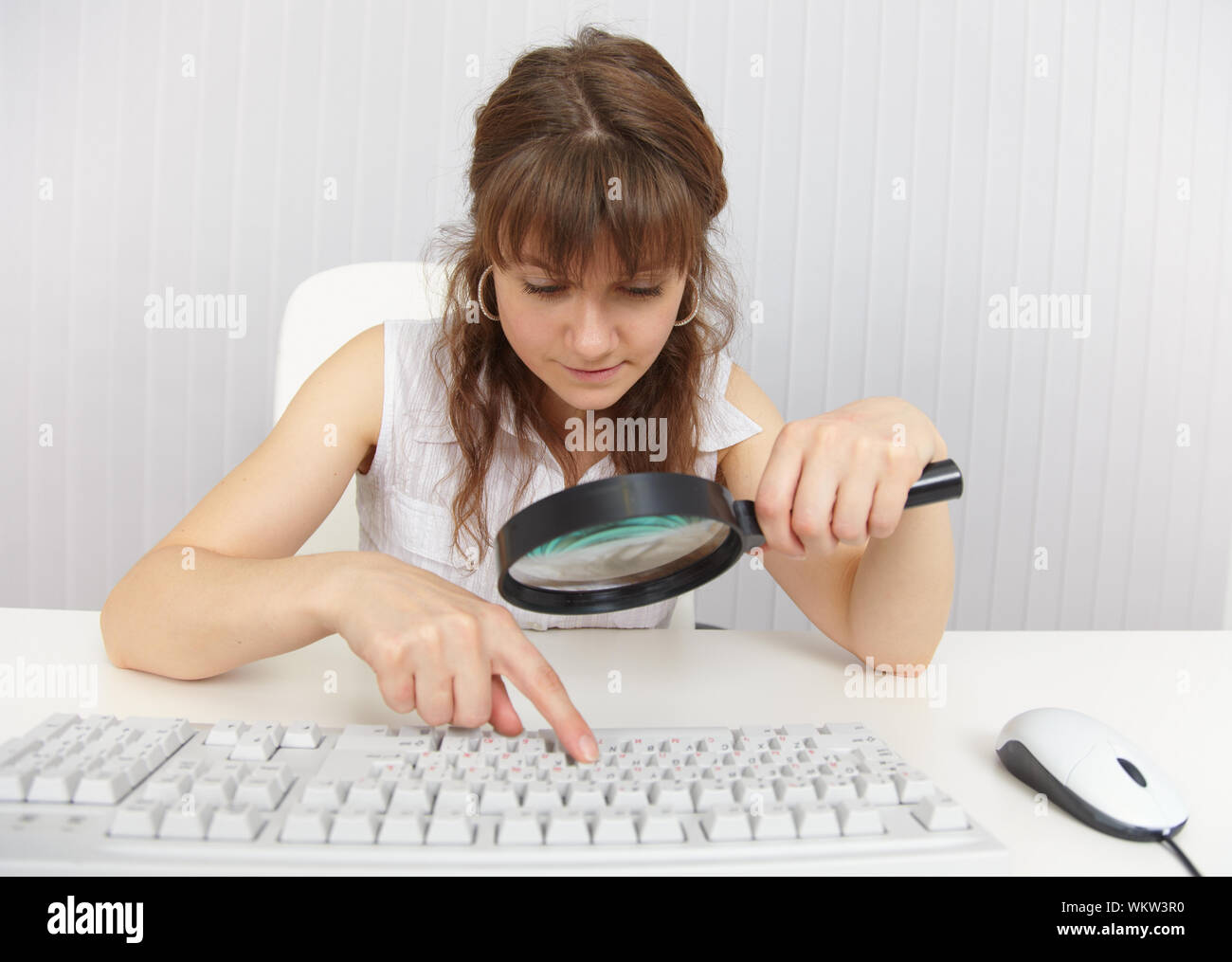 The girl with a poor eyesight works on the keyboard by means of a ...