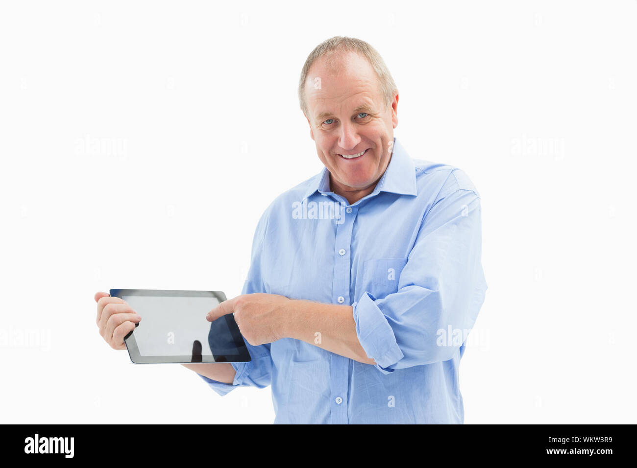 Happy mature man pointing to his tablet pc on white background Stock ...