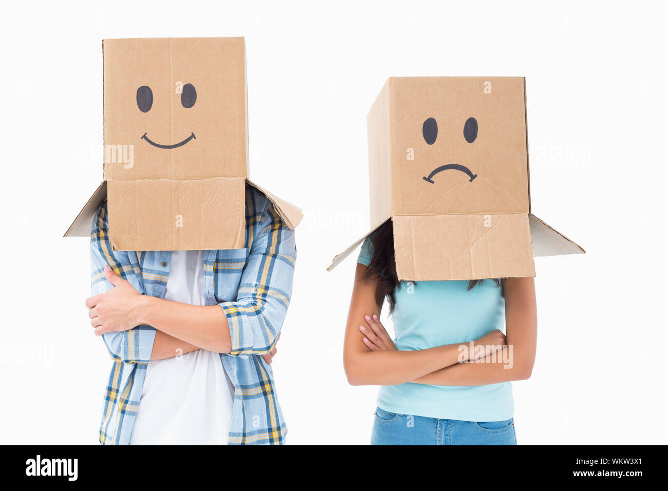 Young couple wearing sad face boxes over head on white background Stock ...