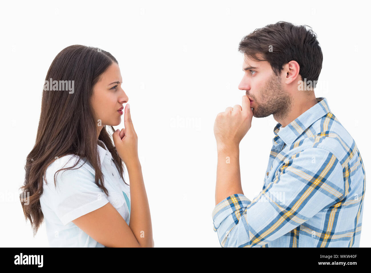 Upset young couple not talking on white background Stock Photo - Alamy