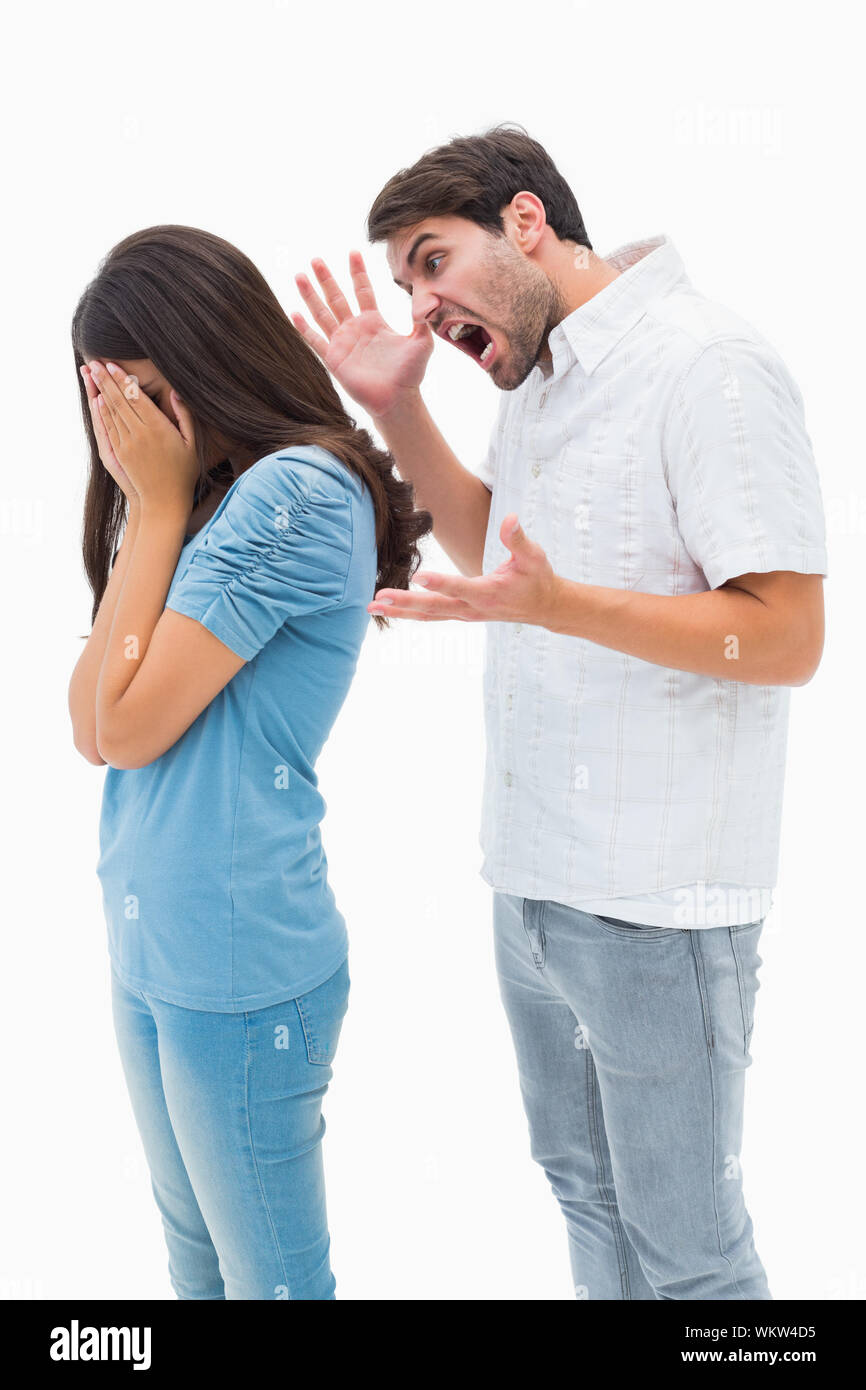 Angry man shouting at girlfriend on white background Stock Photo - Alamy