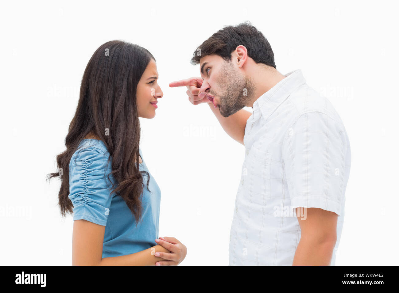 Angry man shouting at upset girlfriend on white background Stock Photo ...