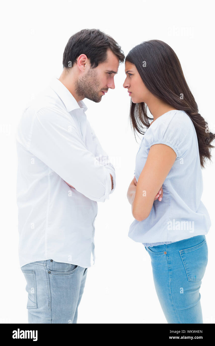 Angry couple facing off after argument on white background Stock Photo ...