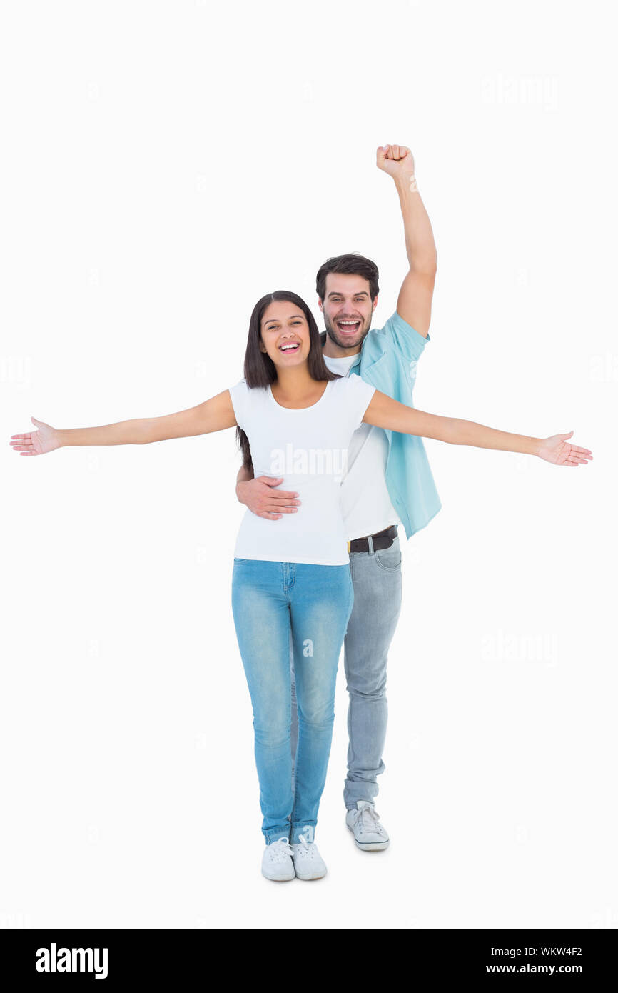 Happy casual couple cheering together on white background Stock Photo ...