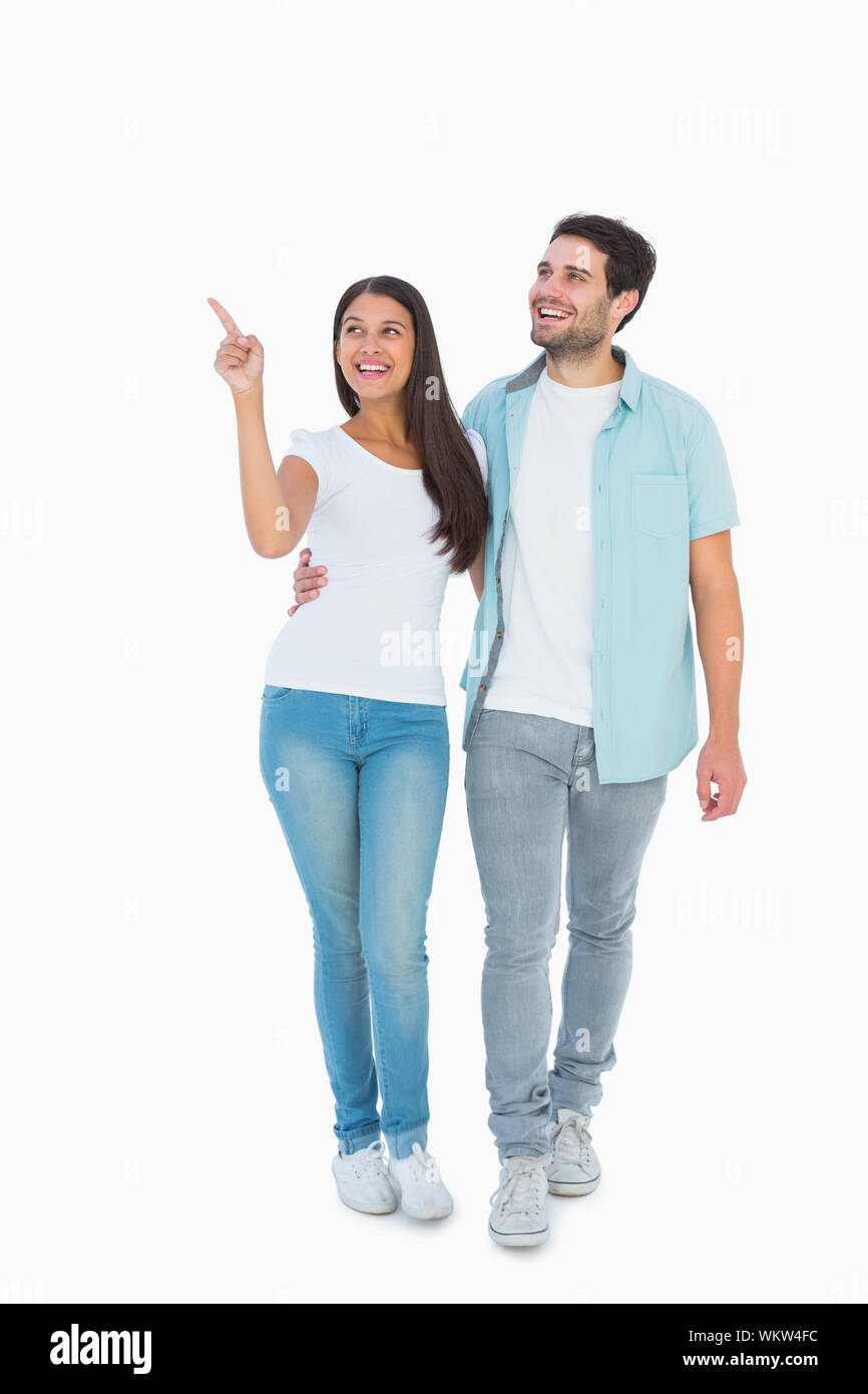 Happy casual couple walking together on white background Stock Photo ...