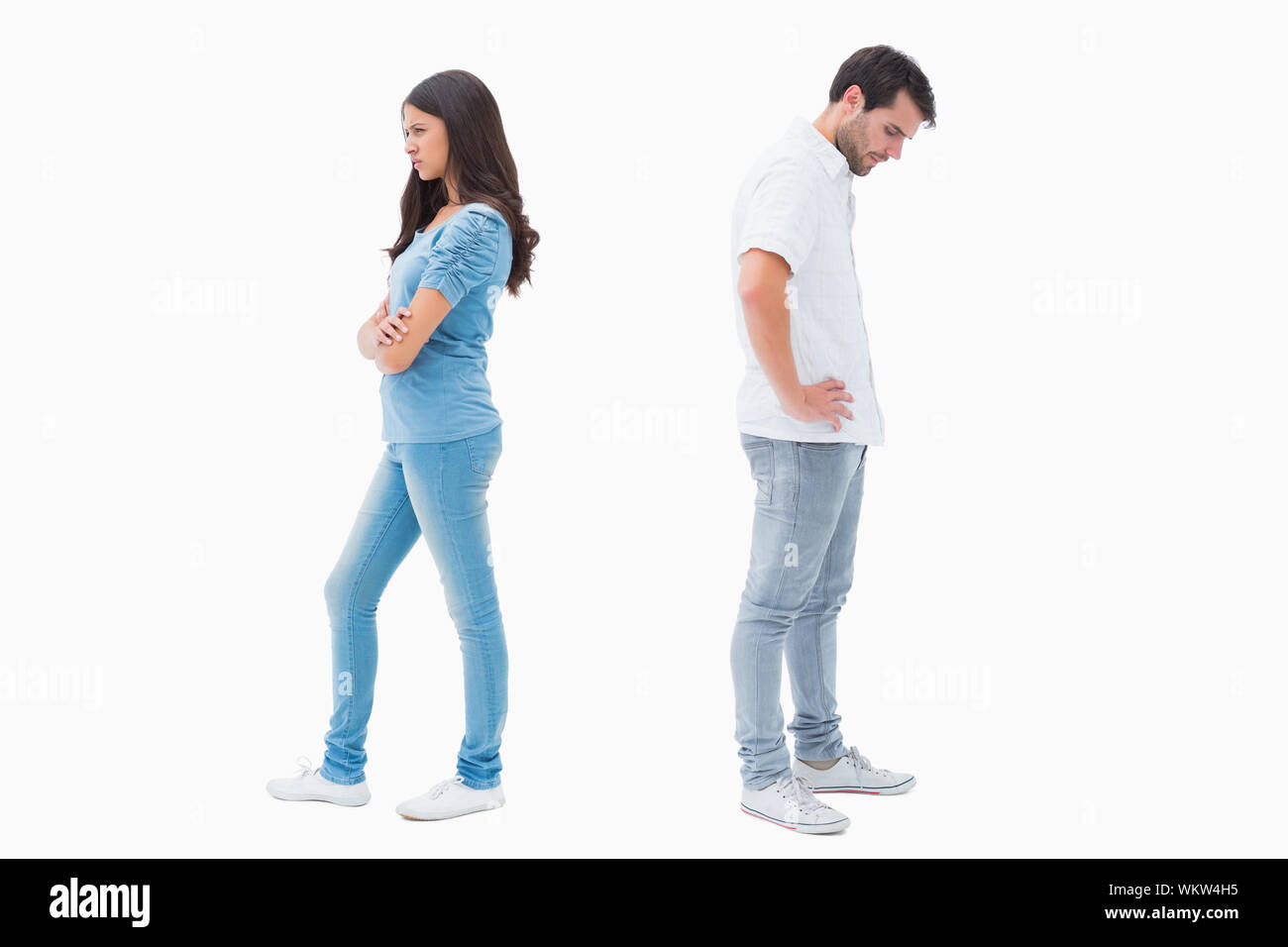 Upset couple not talking to each other after fight on white background ...