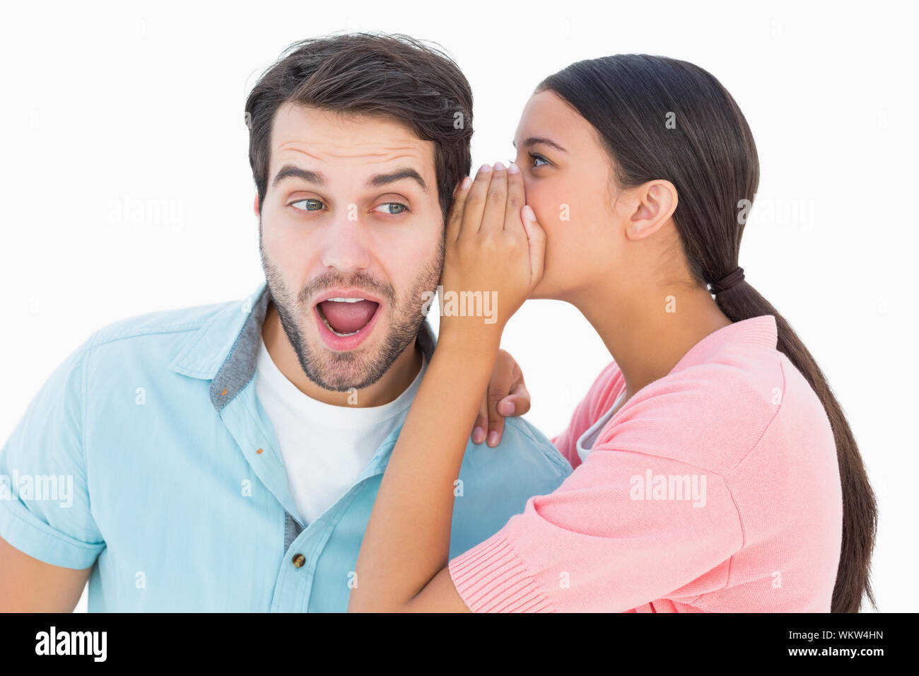Brunette whispering secret to her boyfriend on white background Stock ...
