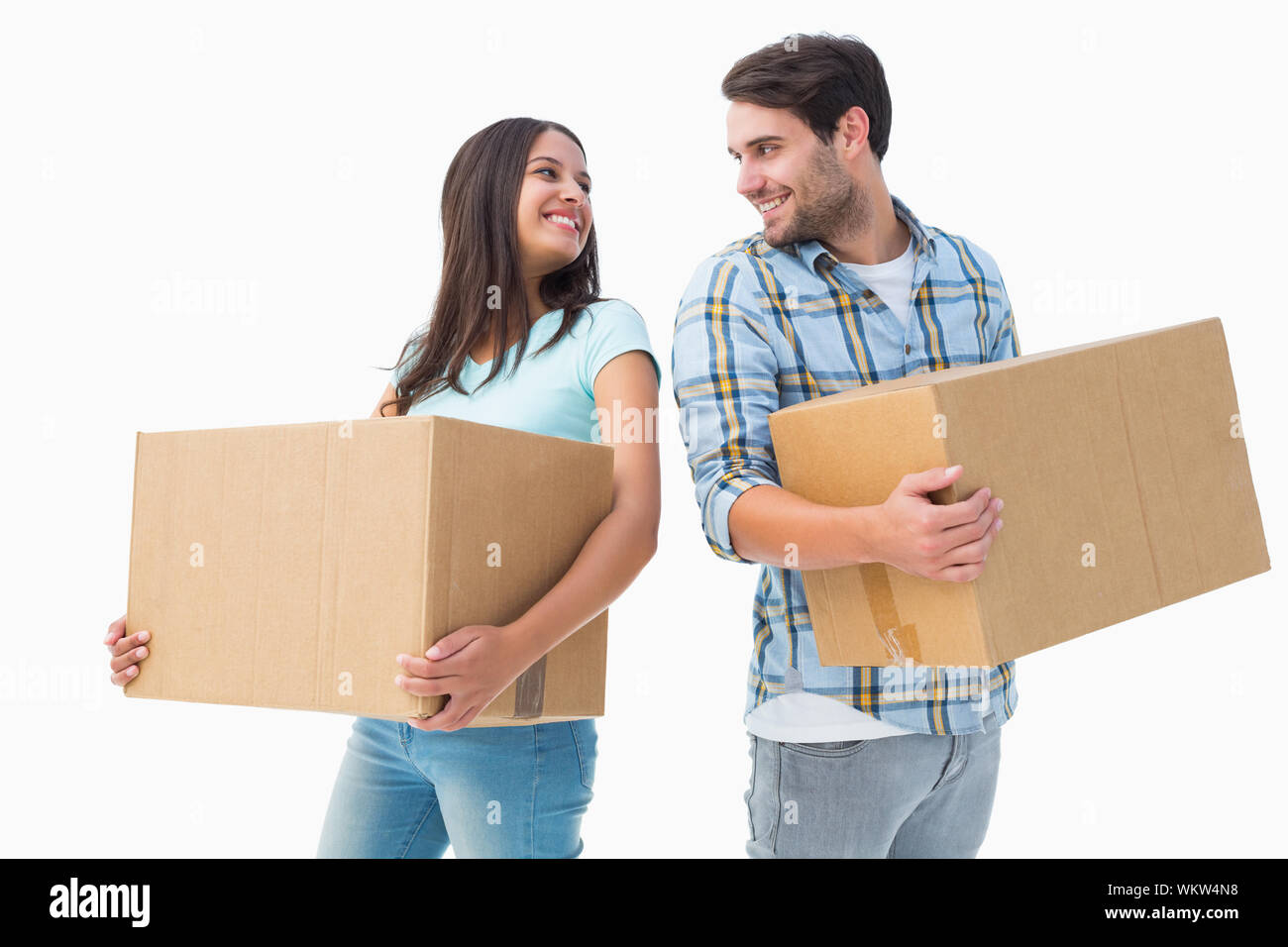 Happy young couple with moving boxes on white background Stock Photo ...