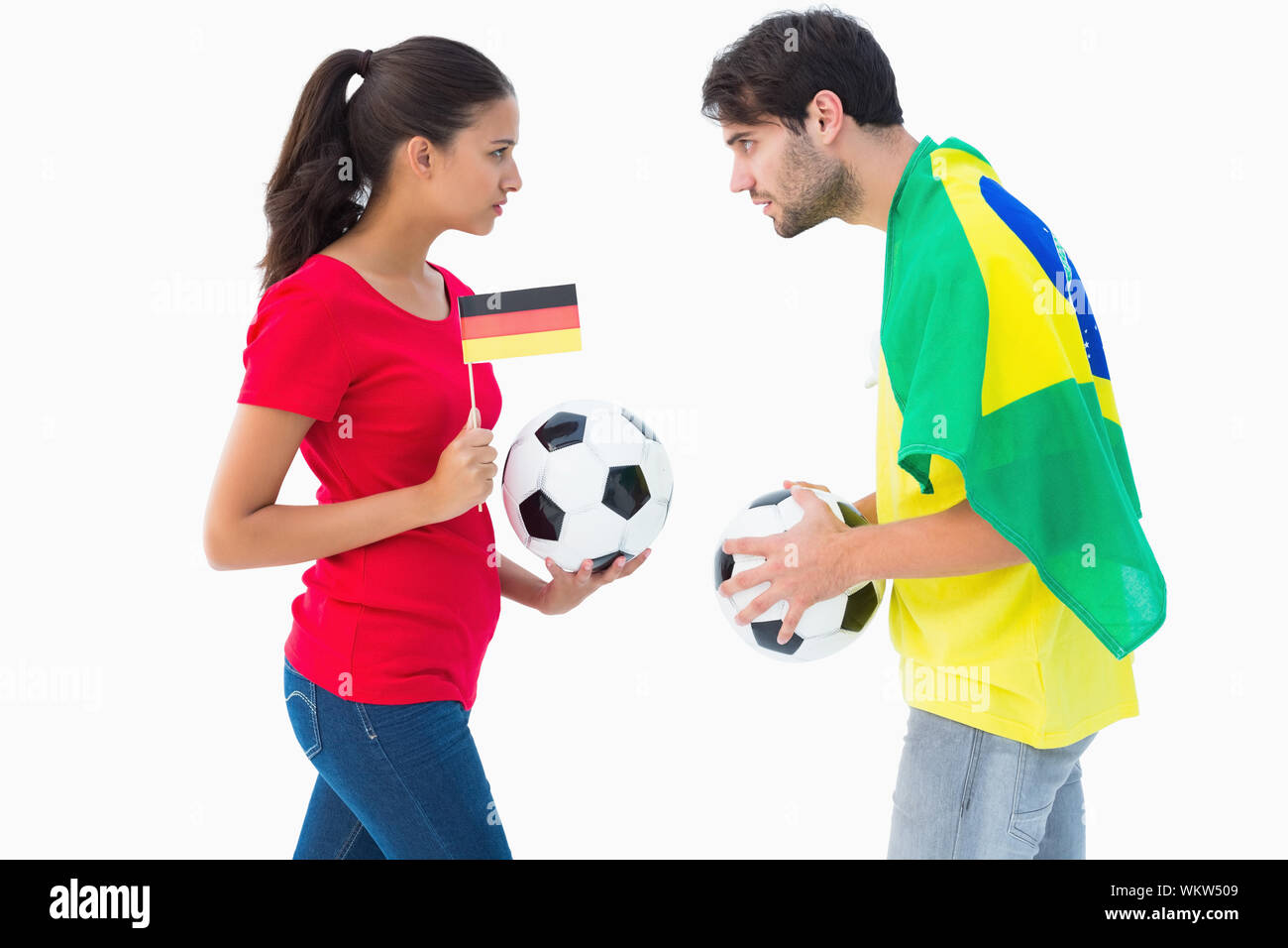 German and brazilian football fan facing off on white background Stock ...