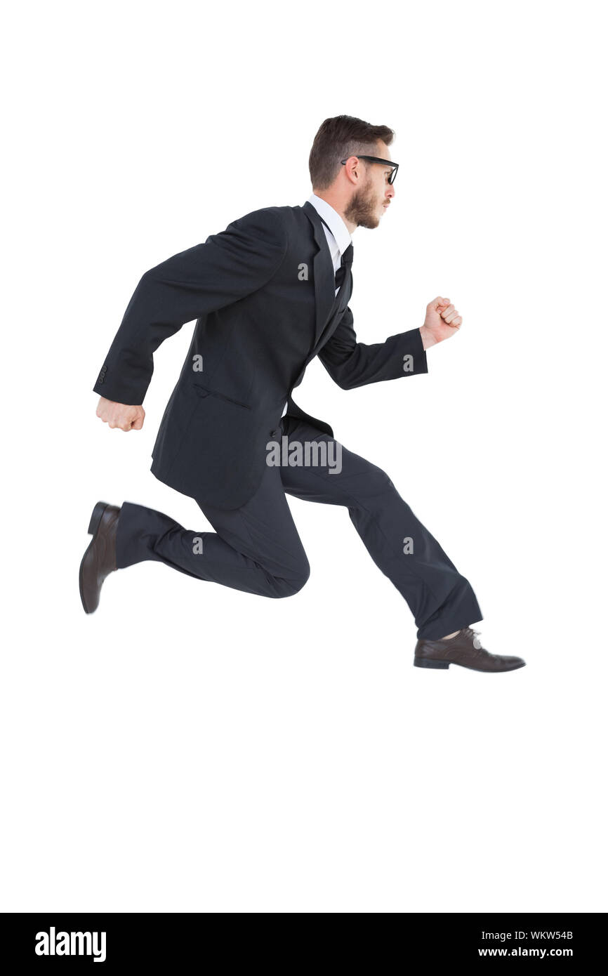 Geeky young businessman running mid air on white background Stock Photo ...