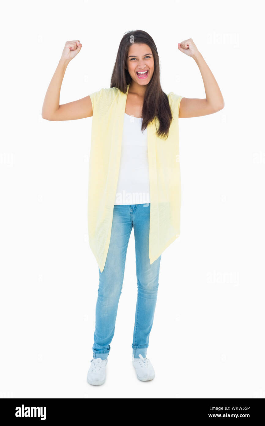 Happy casual woman cheering at camera on white background Stock Photo ...