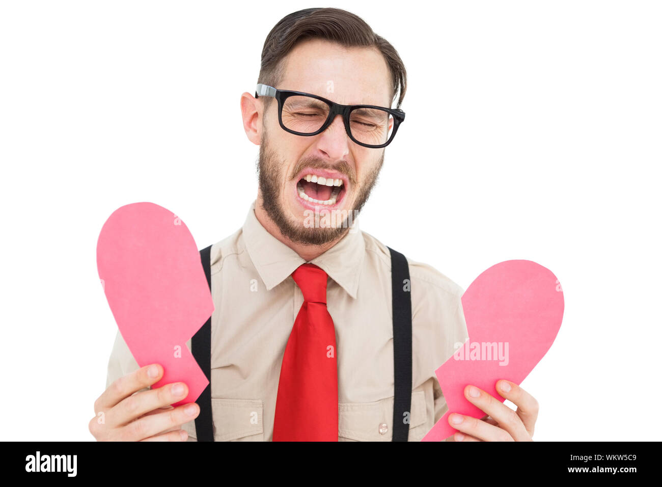Geeky hipster crying and holding broken heart card on white background ...