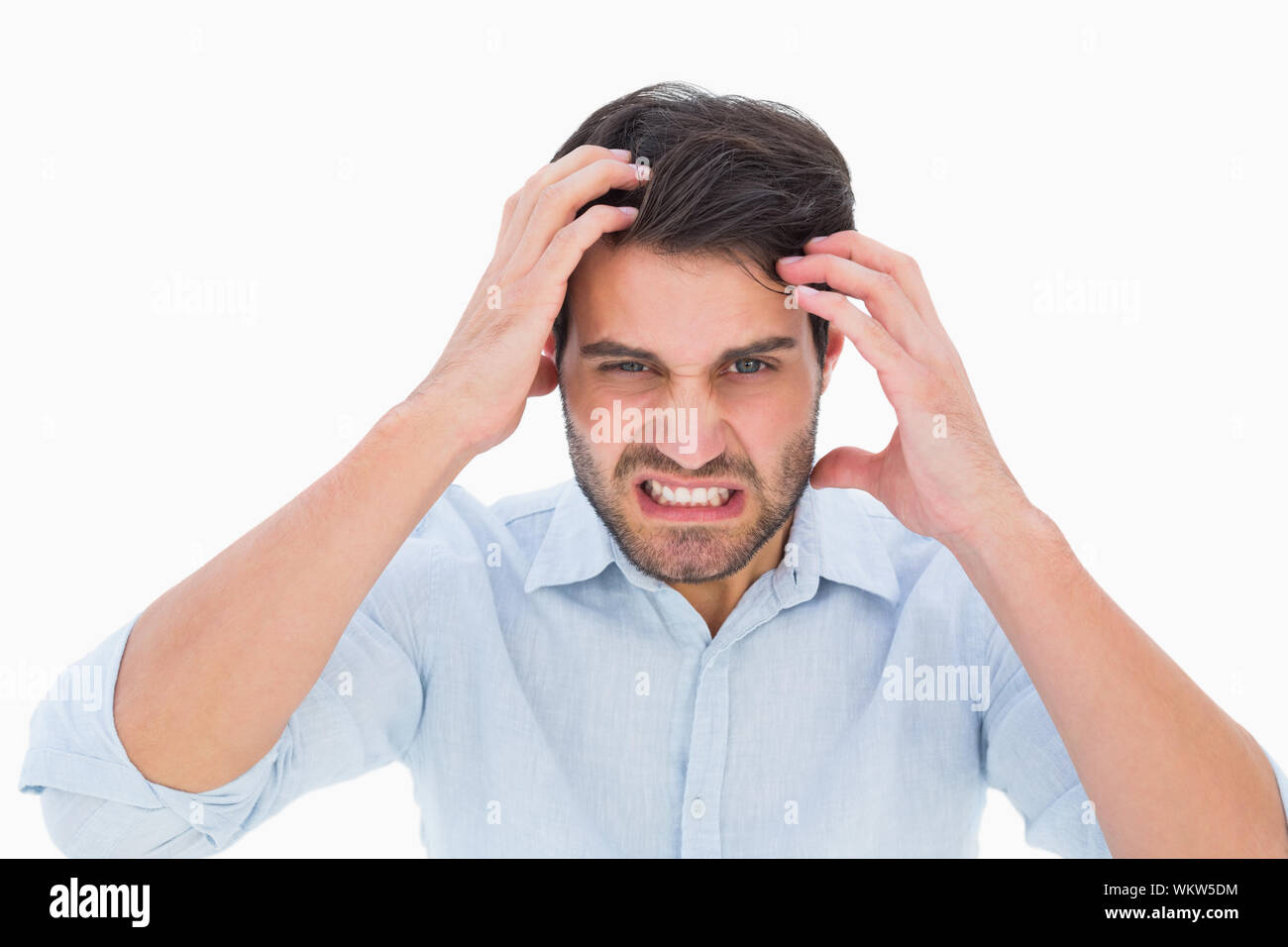 Stressed man looking at camera on white background Stock Photo - Alamy