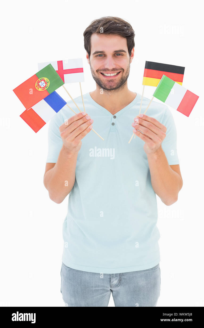 Handsome man holding various european flags on white background Stock ...