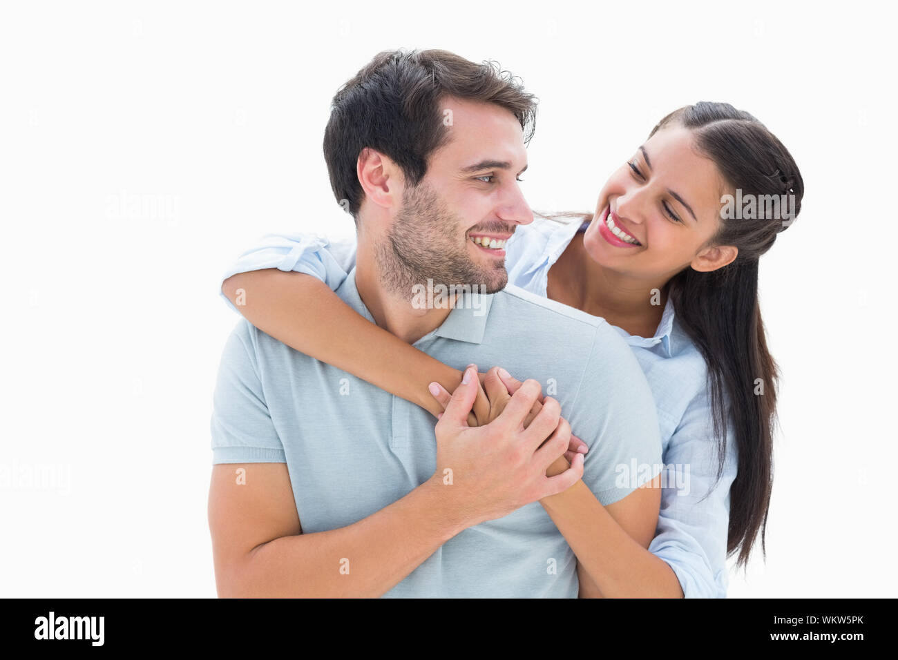 Cute couple smiling at each other on white background Stock Photo - Alamy