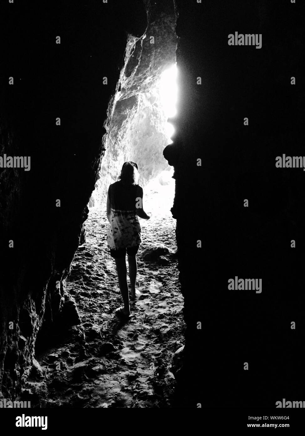 Woman walking in cave hi-res stock photography and images - Alamy