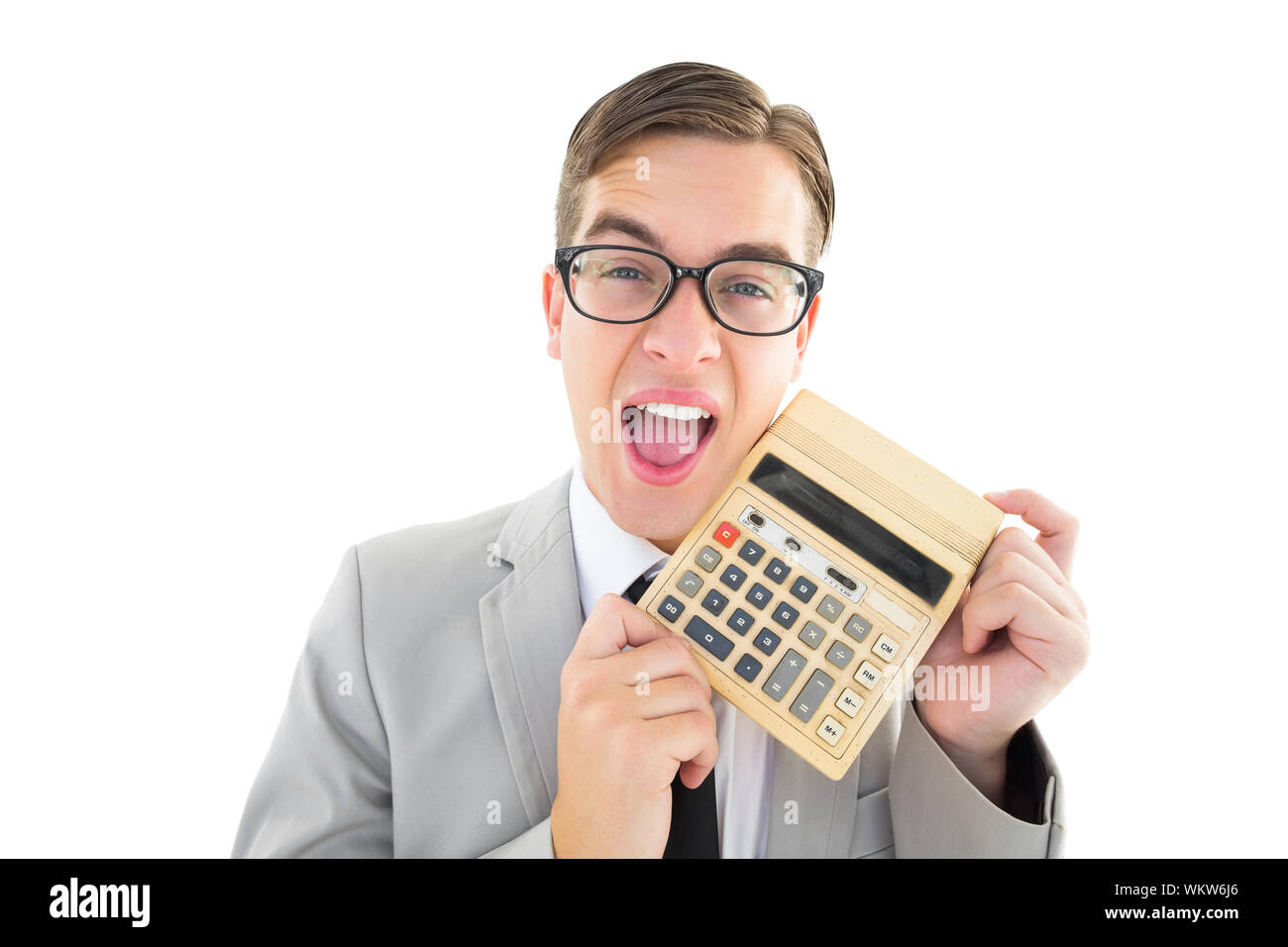 Geeky smiling businessman showing calculator on white background Stock ...