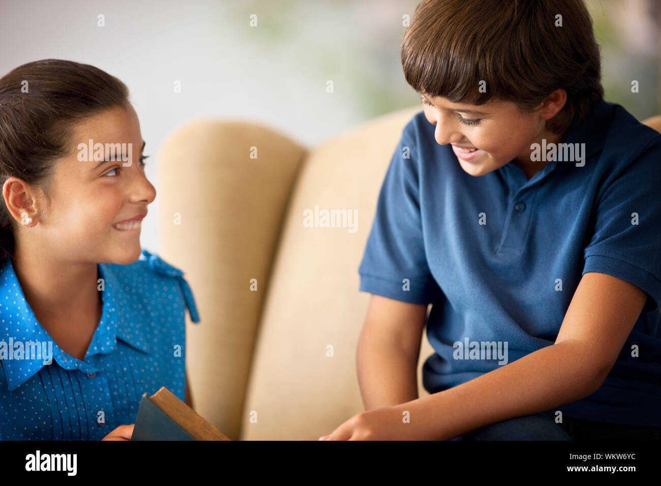 Brother and sister reading a book together Stock Photo - Alamy