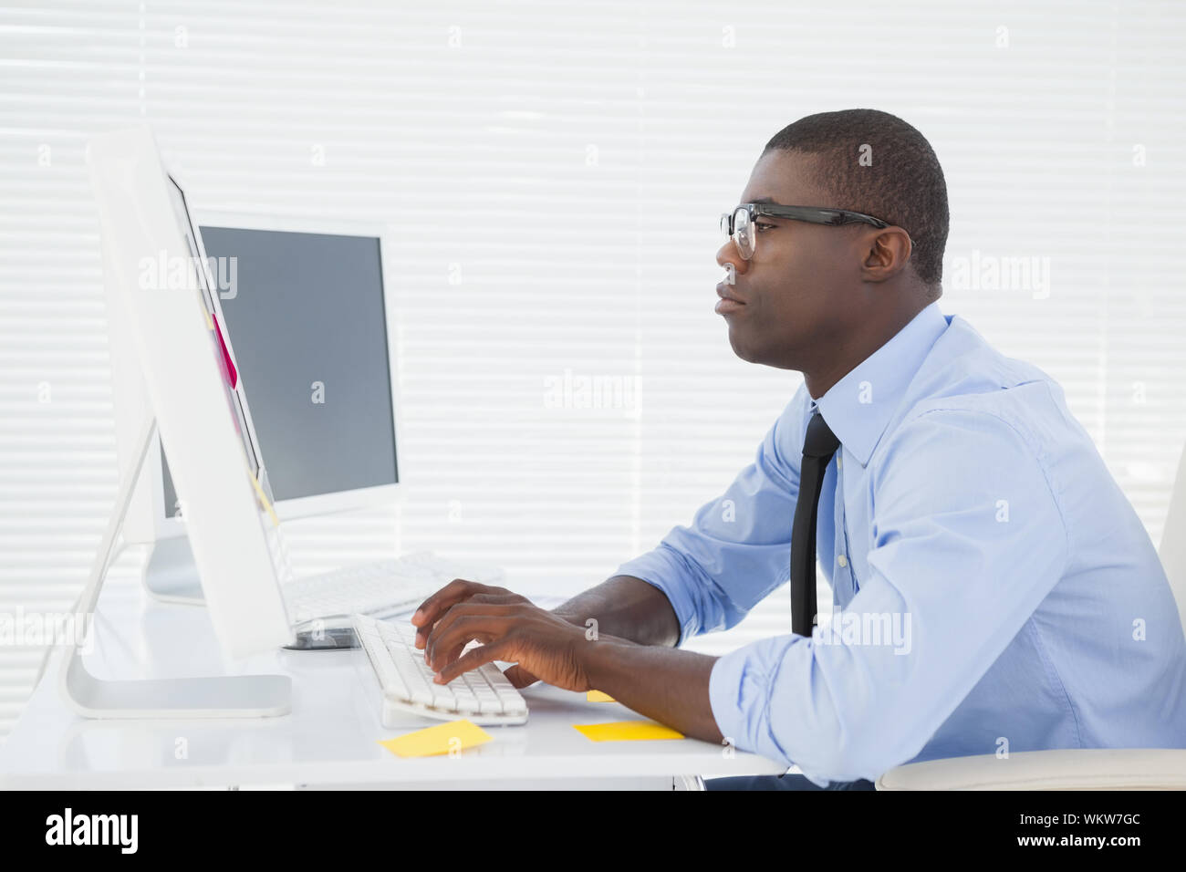 Focused businessman sitting at his desk working in his office Stock ...