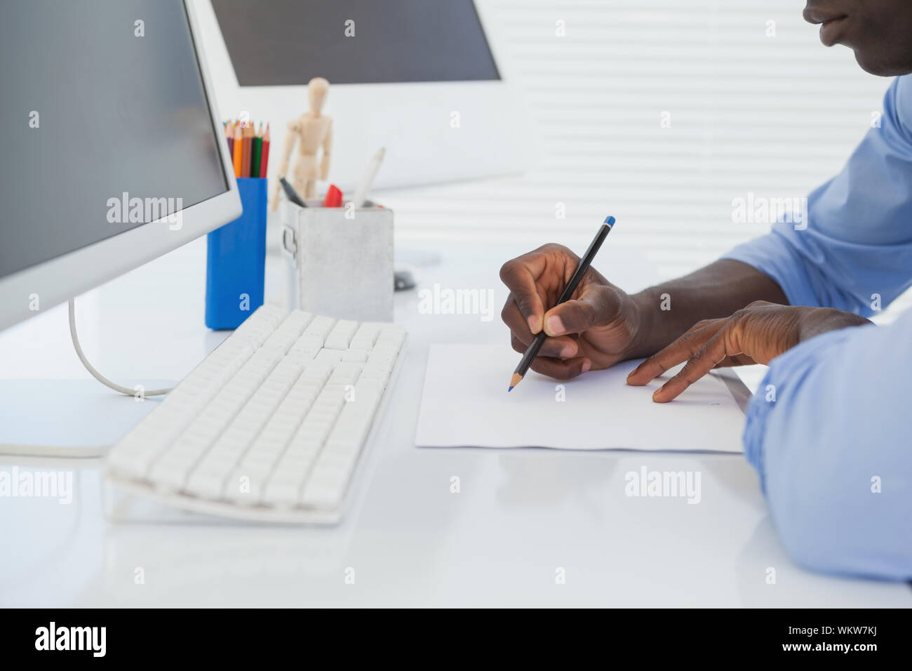 Businessman drawing at his desk in his office Stock Photo - Alamy