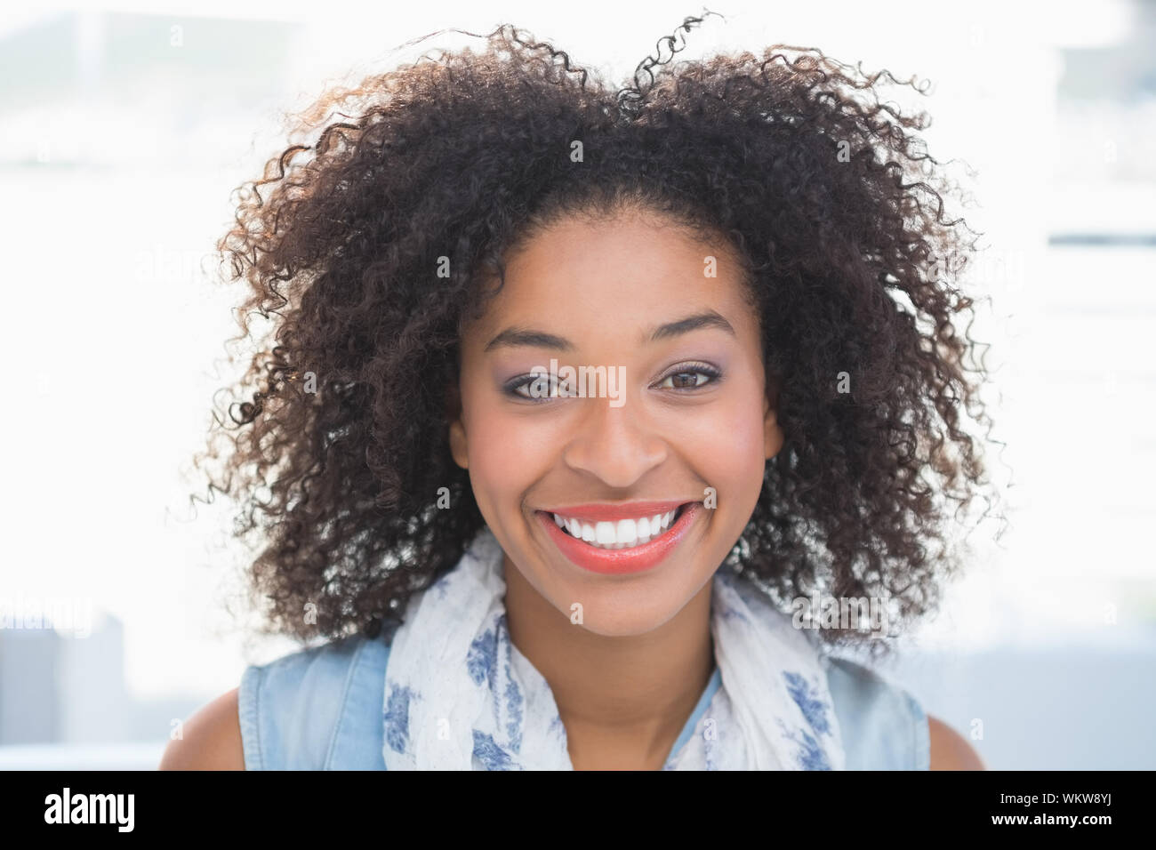 Pretty designer smiling at camera in her office Stock Photo - Alamy