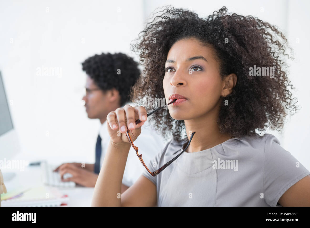 Young editor thinking at her desk in creative office Stock Photo - Alamy