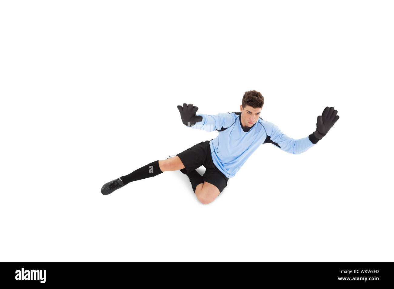 Goalkeeper in blue making a save on white background Stock Photo - Alamy