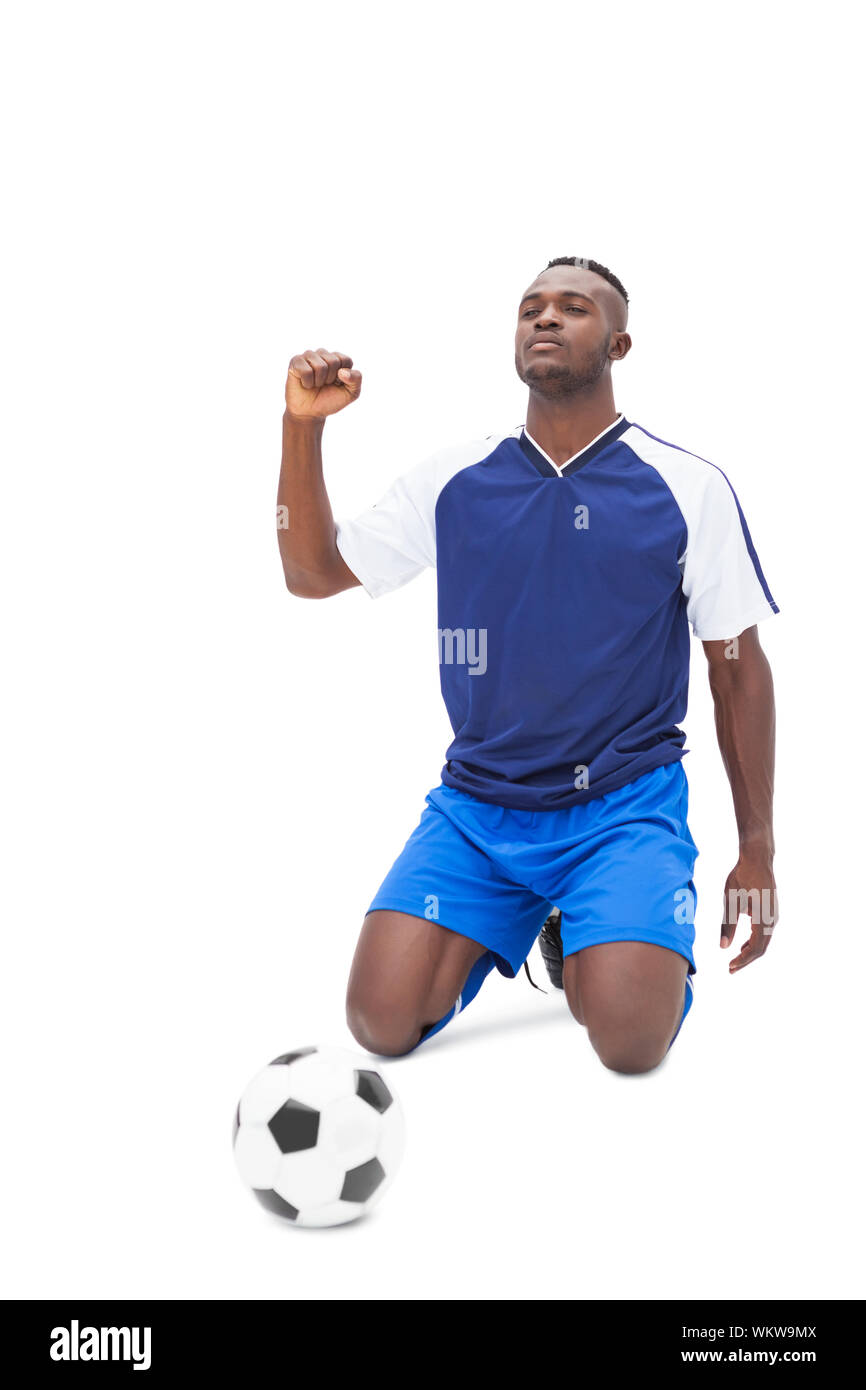 Football player in blue celebrating on white background Stock Photo - Alamy