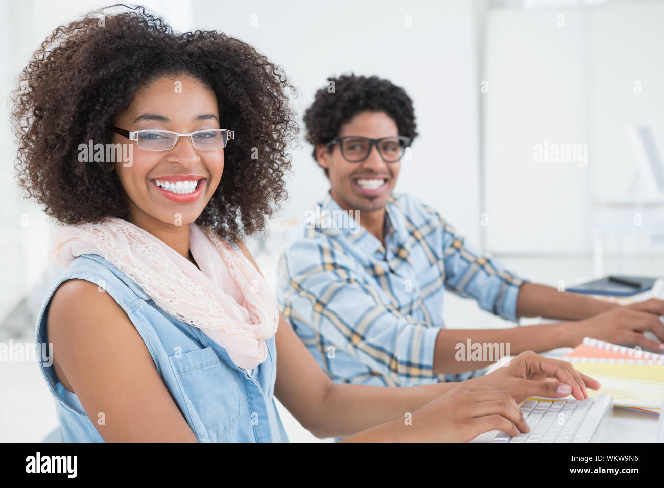 Happy design team working at desk together in their office Stock Photo ...