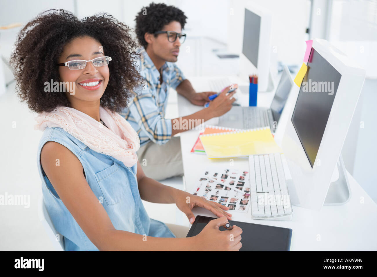Happy design team working at desk in their office Stock Photo - Alamy