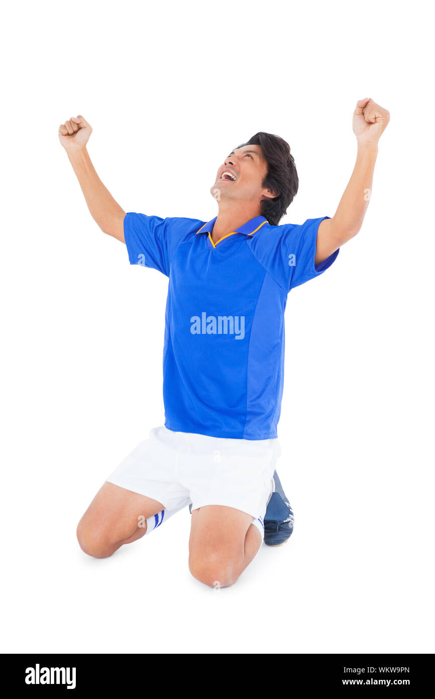 Football player in blue celebrating on white background Stock Photo - Alamy