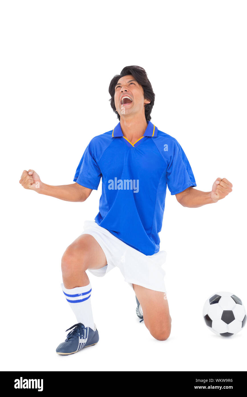 Football player in blue celebrating on white background Stock Photo - Alamy