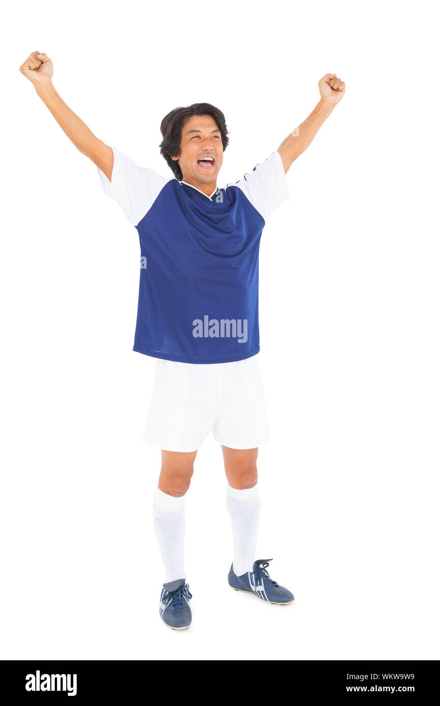 Football player in blue celebrating on white background Stock Photo - Alamy