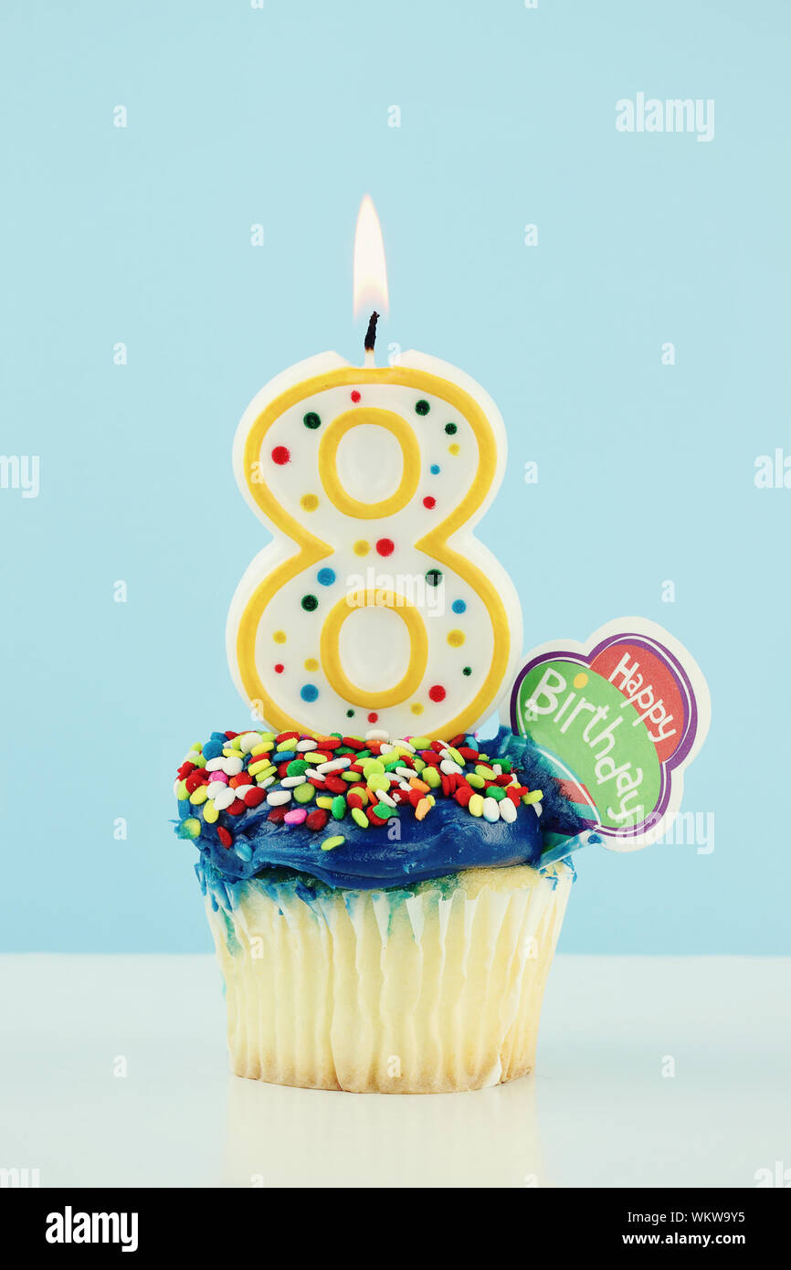 Birthday cupcake with a large number eight candle Stock Photo - Alamy