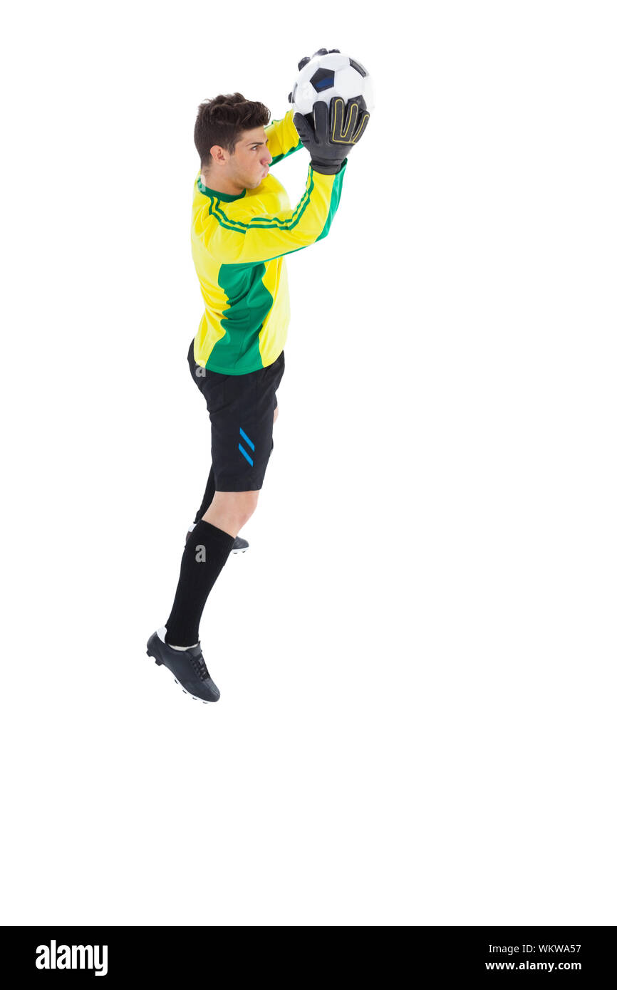 Goalkeeper in yellow making a save against brazil flag in grunge effect ...