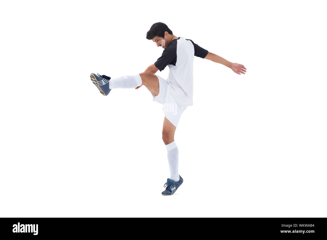 Football player in white kicking on white background Stock Photo - Alamy