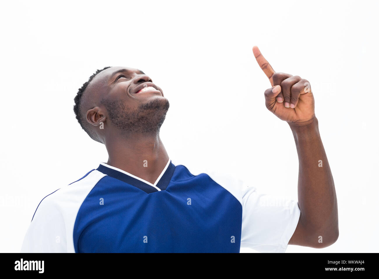 Football player in blue pointing up on white background Stock Photo - Alamy