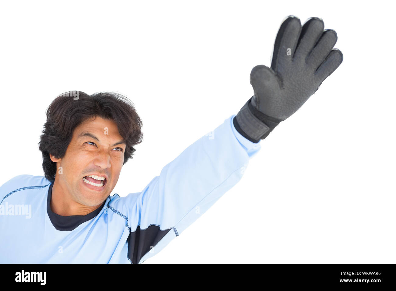 Goalkeeper in blue making a save on white background Stock Photo - Alamy