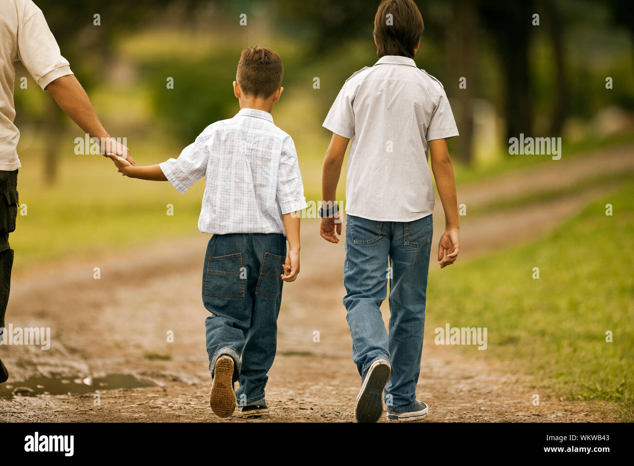 Rear view father children walk road hi-res stock photography and images - Alamy