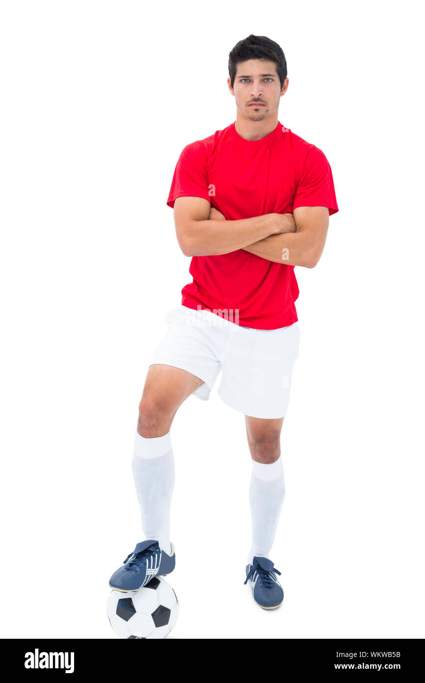 Football player in red standing with ball on white background Stock ...