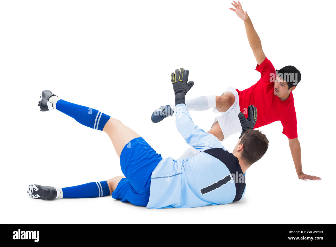 Football player striking at goalkeeper on white background Stock Photo ...