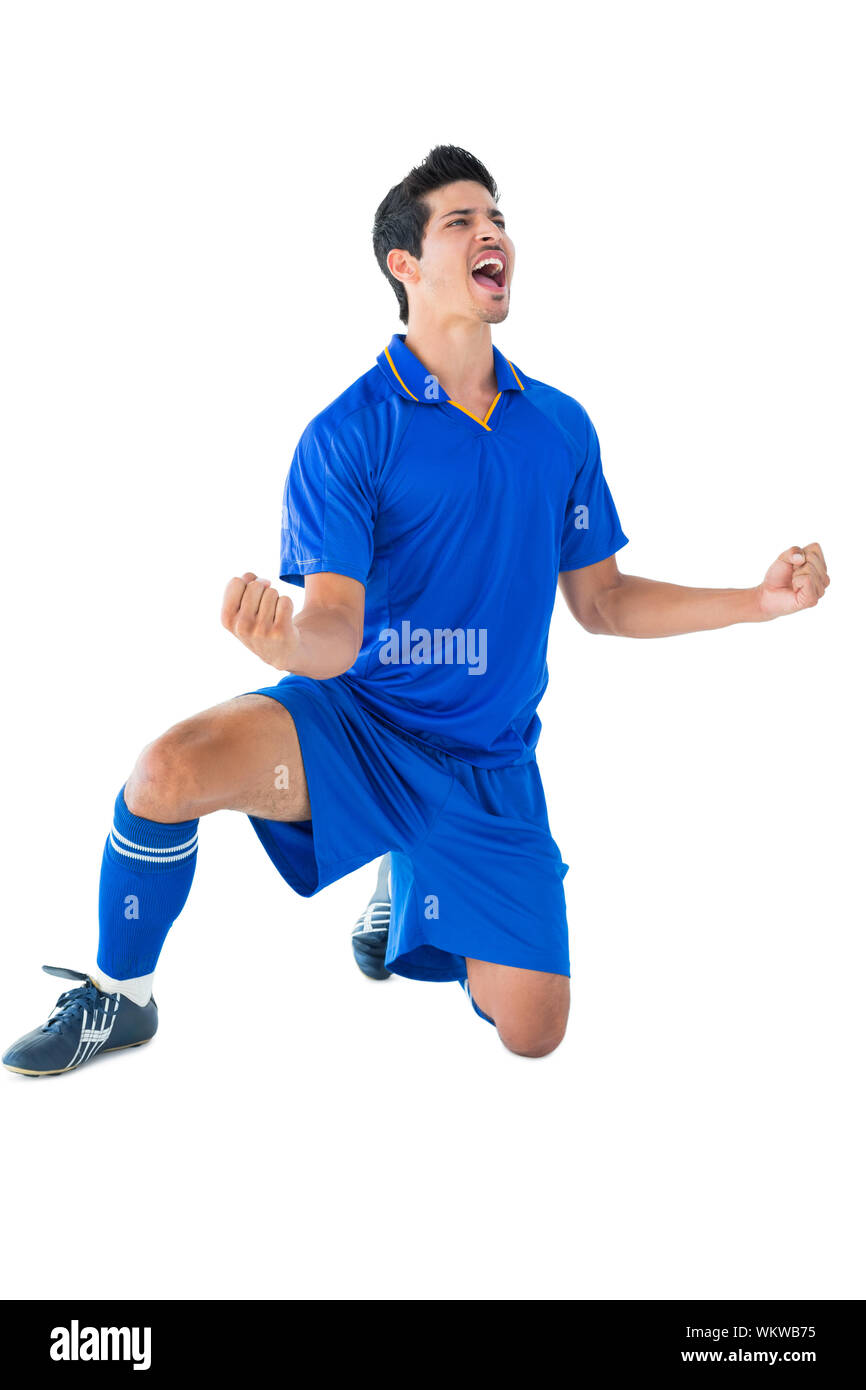 Happy football player in blue celebrating on white background Stock ...