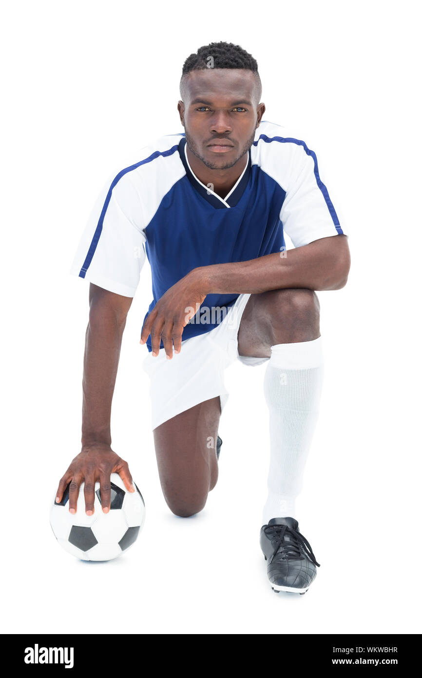 Serious football player in blue jersey on white background Stock Photo ...