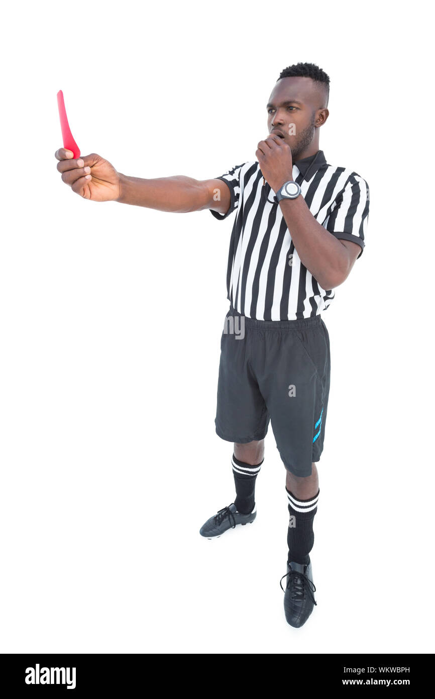 Serious referee showing red card blowing whistle on white background ...
