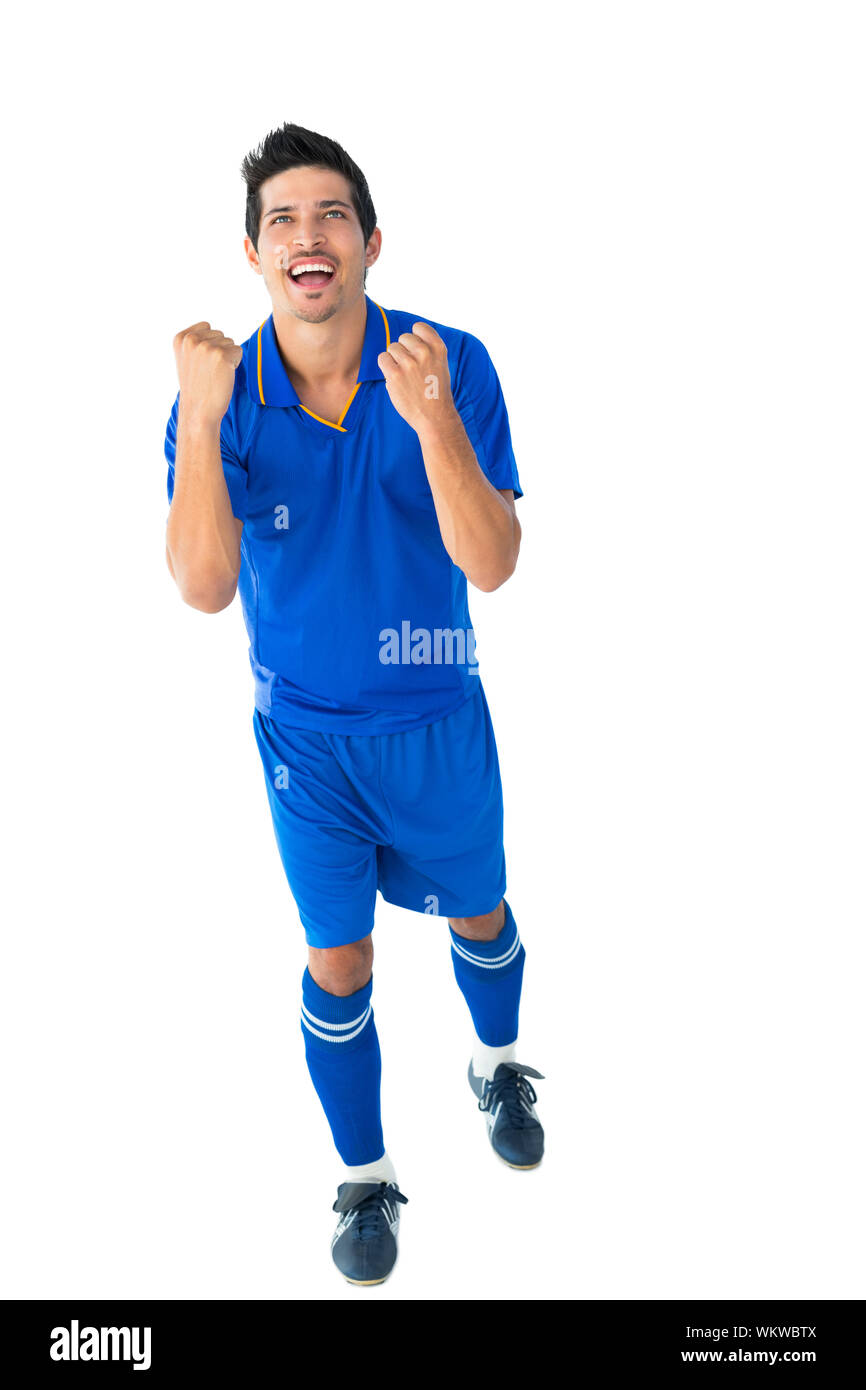 Happy football player in blue celebrating on white background Stock ...