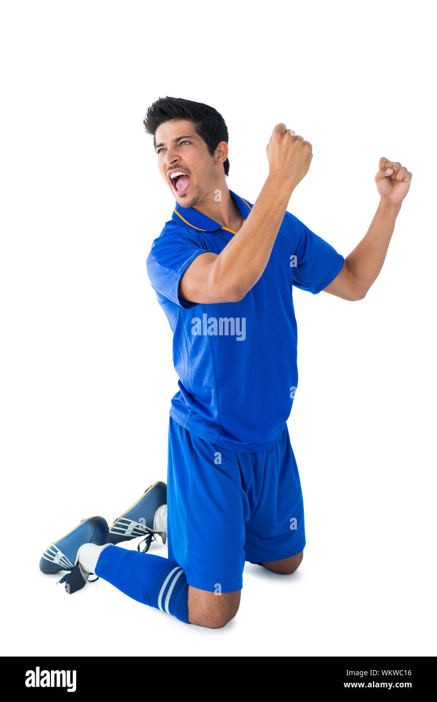 Happy football player in blue celebrating on white background Stock ...