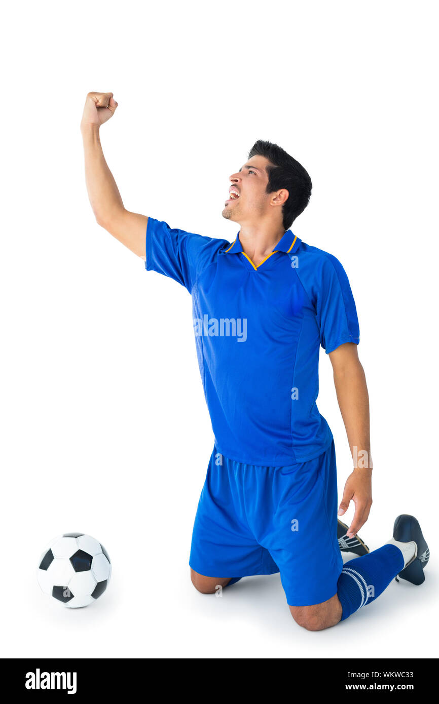 Happy football player in blue celebrating on white background Stock ...